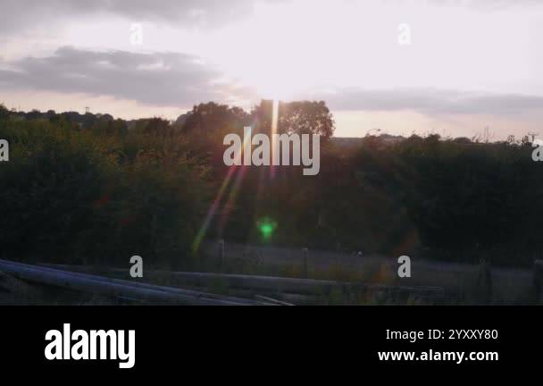 Semi rural English Suburbs and farmland at sunset aerial drone zoom ...