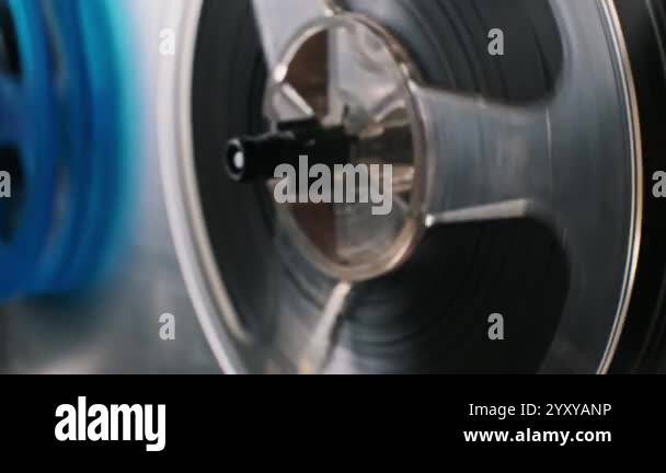 Detailed view of a vintage reel-to-reel tape machine with a blue ...