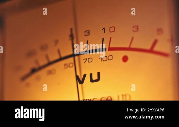 A macro shot of a vintage VU meter with the needle hovering near the ...