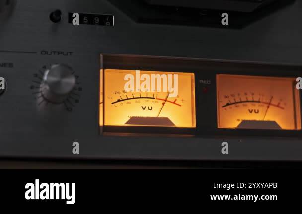 A detailed look at a classic audio control panel featuring two glowing ...