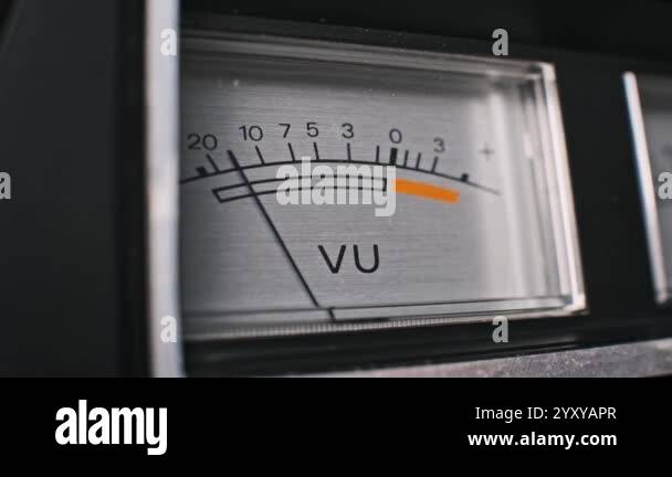 Detailed close-up of a retro-style VU meter. The needle shows a ...