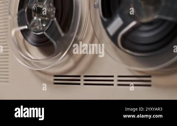 A nostalgic capture of a vintage reel-to-reel tape recorder, focusing ...
