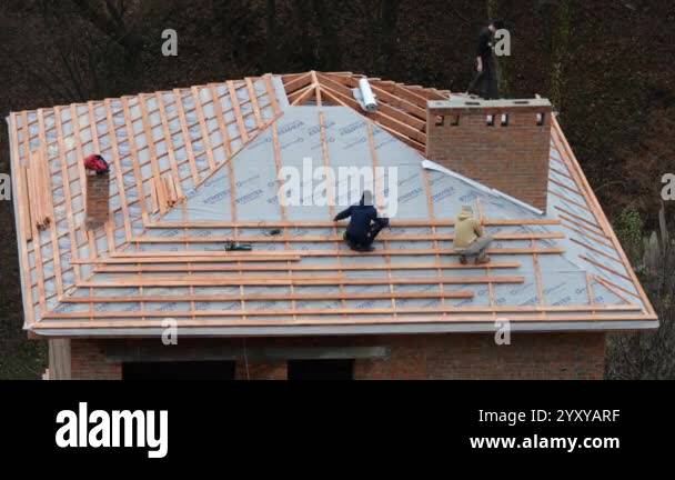 LVIV, UKRAINE - DECEMBER 05, 2024: Male construction workers building a ...