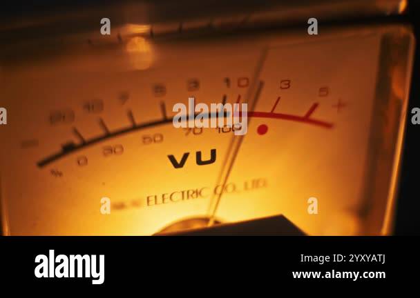 A vibrant close-up of a classic analog VU meter showing the needle in ...