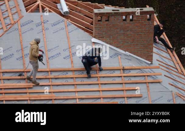 LVIV, UKRAINE - DECEMBER 05, 2024: Male construction workers building a ...