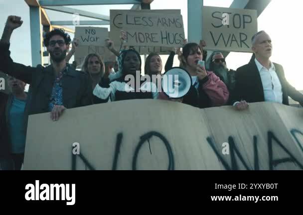Brave diverse group shaking fist demonstrating against war and violence ...