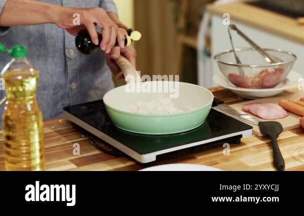 Close up of a person adding soy sauce to a pan of rice, process of ...
