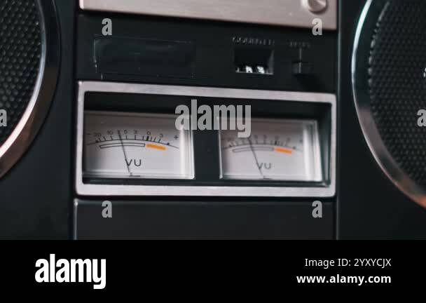 Close-up shot of a vintage boombox cassette player with VU meters and a ...