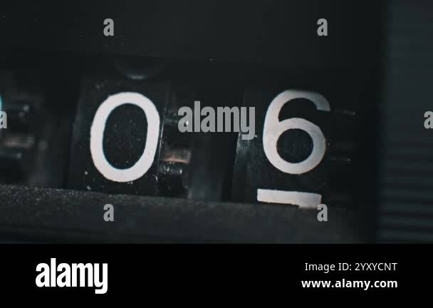 Detailed view of a vintage mechanical counters digits changing from 005 ...
