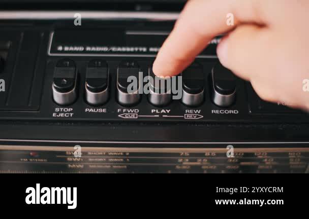 Close Up Finger Engages The Play Button On A Retro Boombox Bringing