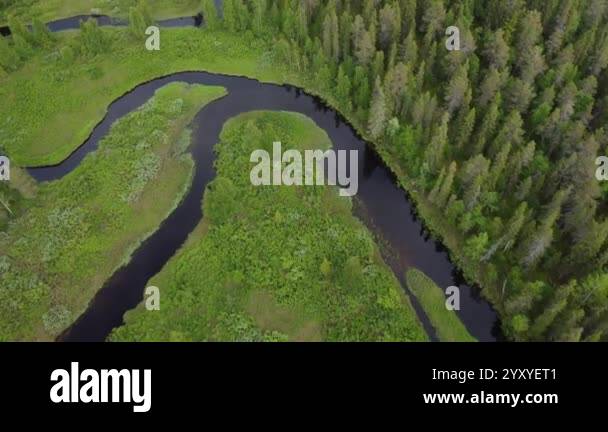 Flying forward over meandering river and forest in Finnish Lapland ...