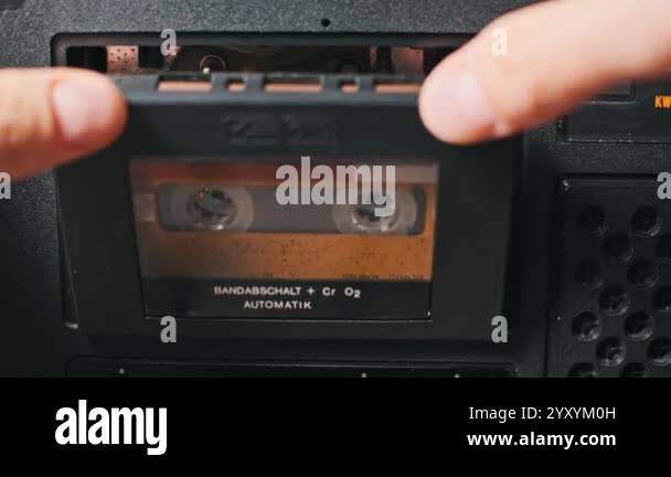A cassette tape is inserted into the cassette player. Close up view ...