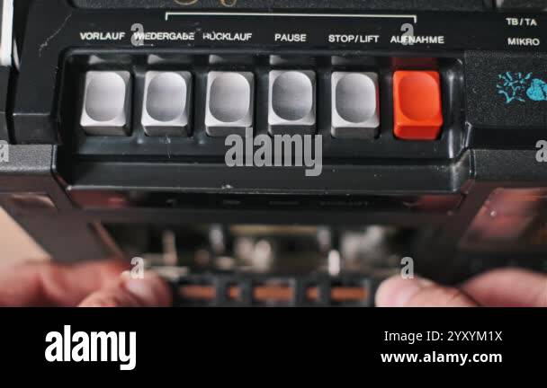 Close-up of a cassette being smoothly inserted into a vintage tape ...