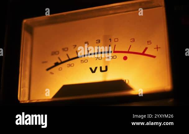 A detailed close-up of an illuminated vintage VU meter showcasing ...