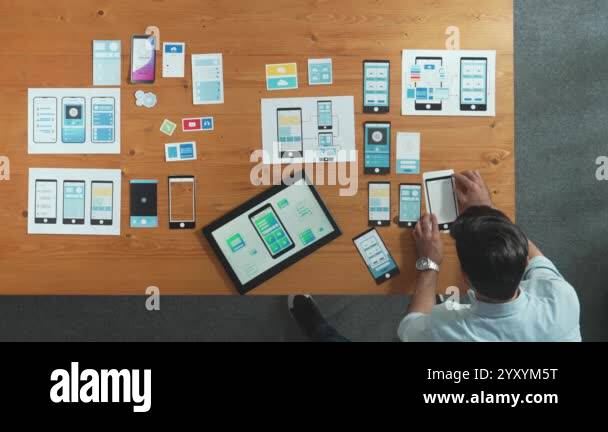 Top view of skilled developer walking and placing Ux Ui software. Smart ...