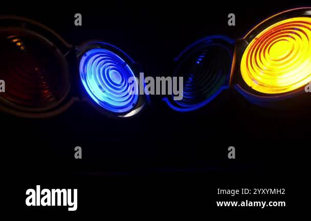 Four round LED lights in a row glow in different colors, creating a ...