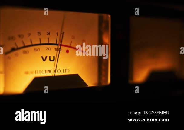 Close-up of a vintage VU meter needle fluctuating. Warm, orange ...
