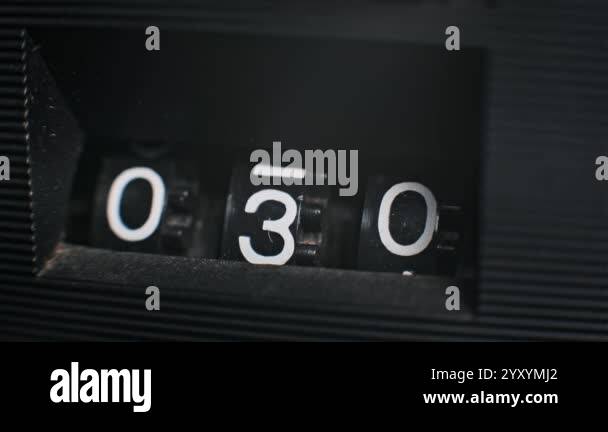 Close-up shot of a retro mechanical counter rotating, showing numbers ...