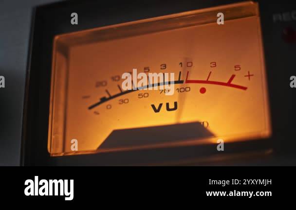 Close-up of an analog VU meter dynamically displaying audio levels, perfect for illustrating ...