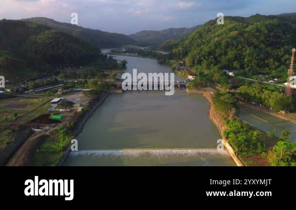 Aerial drone view of the Serayu River, the highway and railroad tracks ...