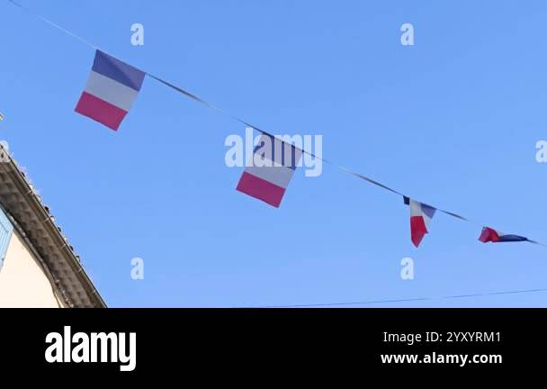 Bunting of French flags hanging under a blue sky Stock Video Footage ...
