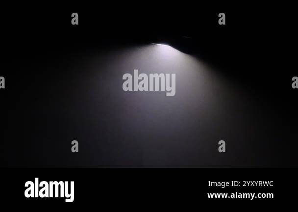 Mist floating past a street lamp at night, close view. illuminated by ...