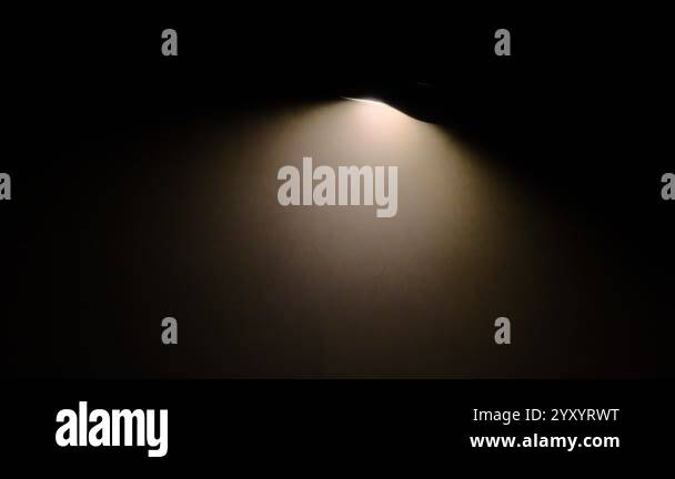 Mist floating past a street lamp at night, close view. illuminated by ...