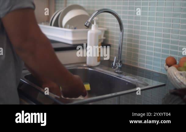 People are washing dishes in a sink in the kitchen Stock Video Footage ...