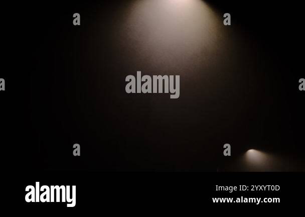 Mist floating past a street lamp at night, close view. illuminated by ...