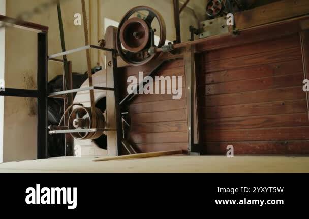 Close-up view of a vintage industrial machine with wooden and metal ...
