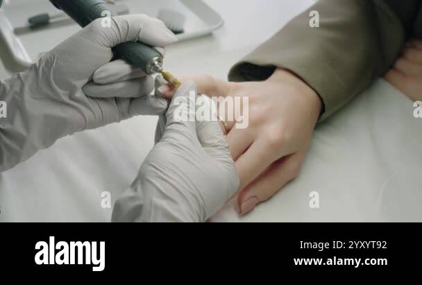 Master manicurist doing manicure procedure for woman client in beauty ...