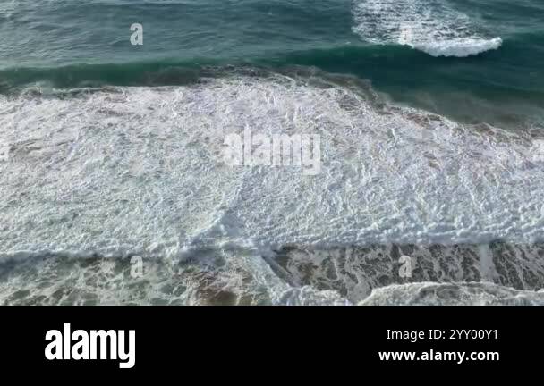 Ocean waves in slow-motion, crashing against a rocky shore ...