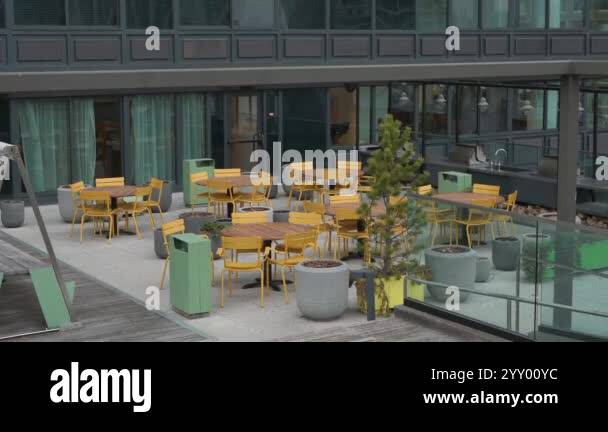 A vibrant outdoor seating area featuring yellow furniture and greenery ...