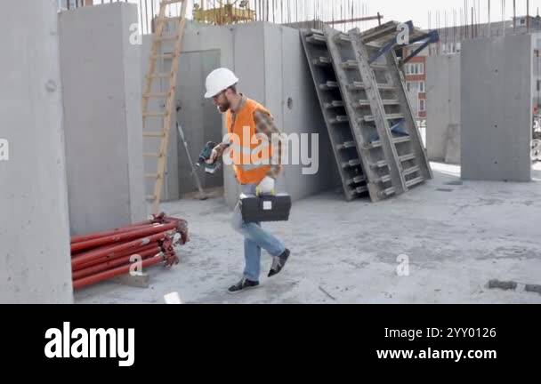 Funny construction worker dancing. Positive dance of builders in helmet ...