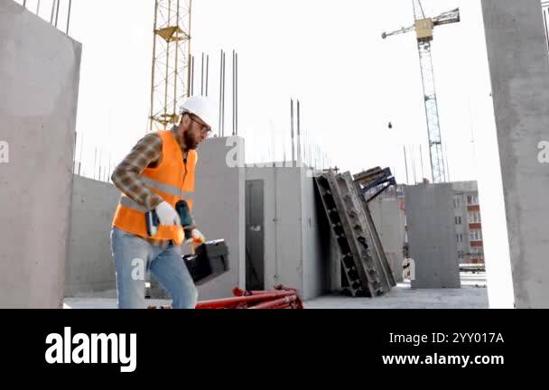 Funny construction worker dancing. Positive dance of builders in helmet ...