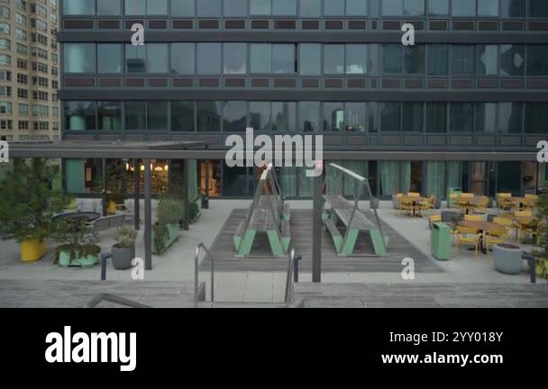 This rooftop space features swings, greenery, and vibrant seating ...