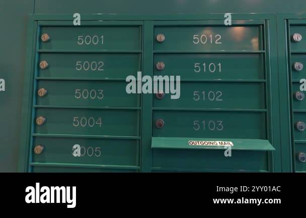 A long row of vibrant green mailboxes that display distinct and unique ...
