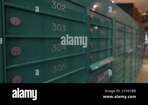 A long row of vibrant green mailboxes that display distinct and unique ...