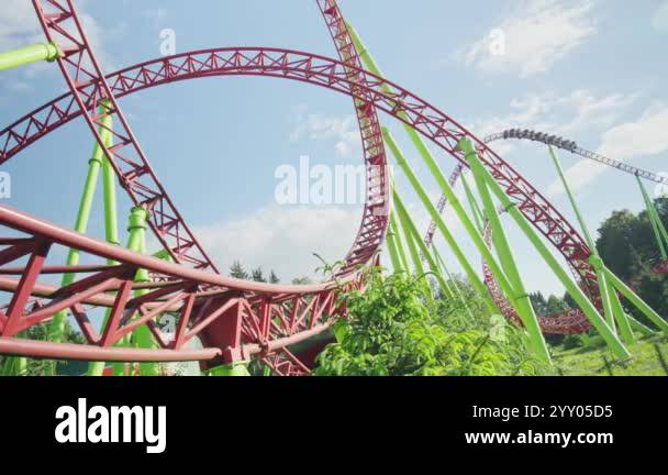 Roller coaster Ride against blue sky. Roller coaster in the amusement ...