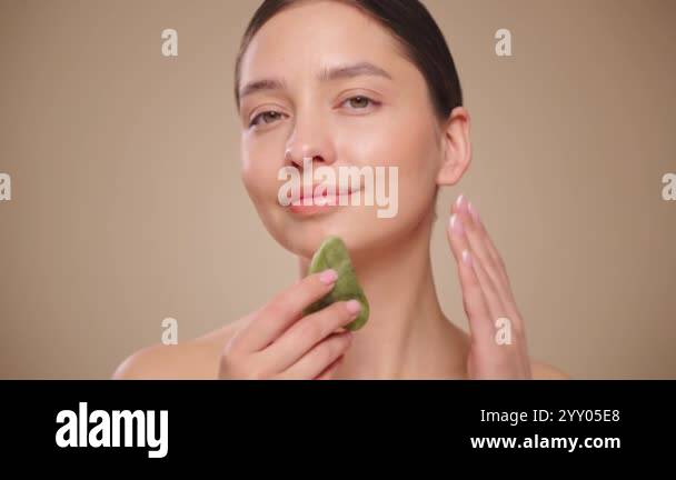 Beauty young woman doing skin care routine, scrapping, massage facial ...