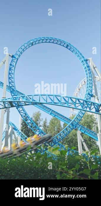 Roller coaster Ride against blue sky. Roller coaster in the amusement ...