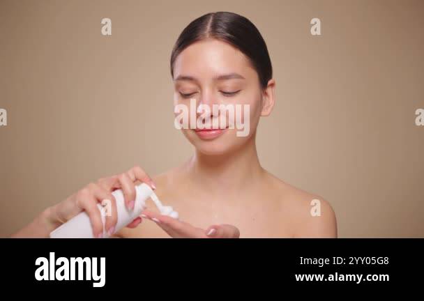 Young woman washes face with face wash foam. Daily facial skin care ...