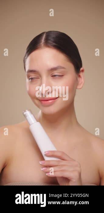 Beautiful woman with bottle of moisturizer cream. Video of woman with ...