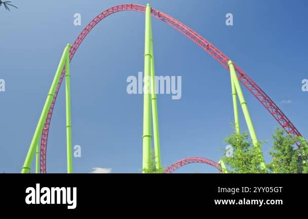 Roller coaster Ride against blue sky. Roller coaster in the amusement ...