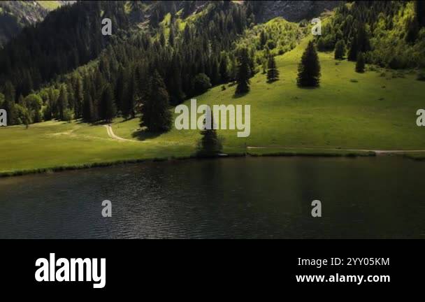 Incredible drone shot of a Lauenensee lake in the Swiss Alps with a ...
