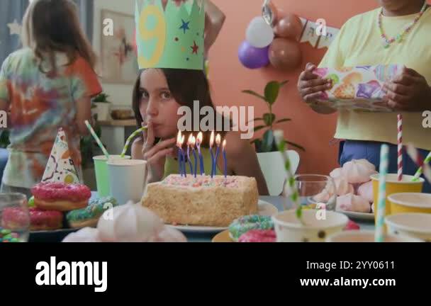 Portrait of nine year old girl drinking beverage through straw and ...