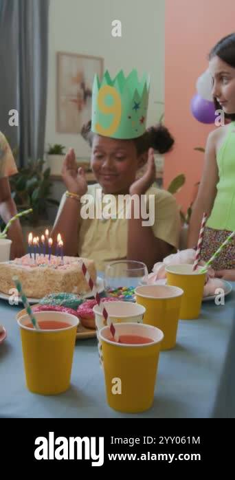 Vertical shot of gen alpha girl with toy crown hiding face behind hands ...