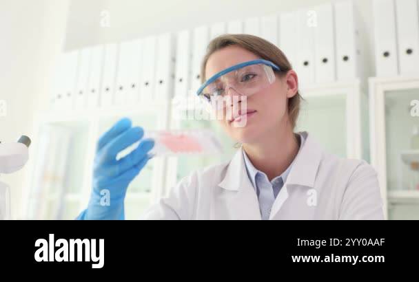 Woman researcher monitors changes in samples intently. Professional ...