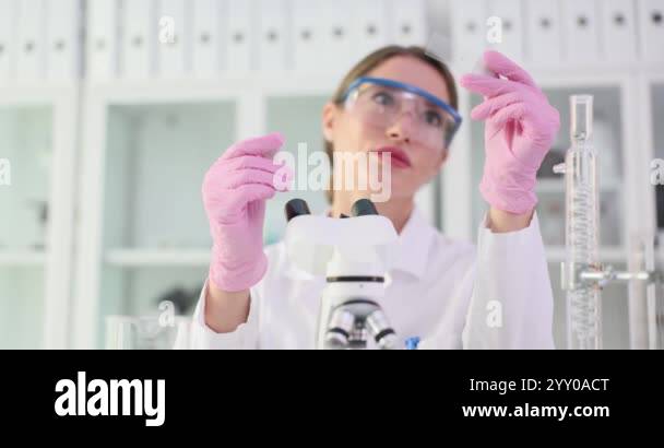 Woman laboratory assistant compares samples to identify visible ...