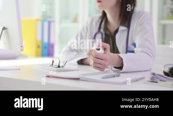 Woman doctor squeezes stress ball sitting at workplace in hospital ...